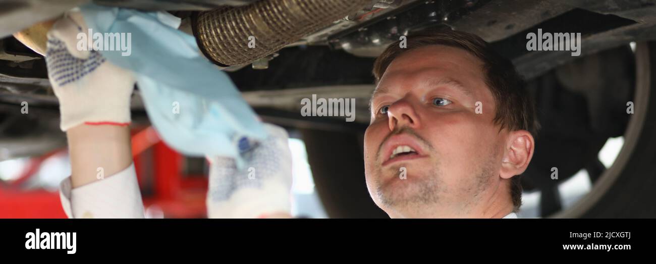 Man repairman repairing car under hood at service station Stock Photo ...