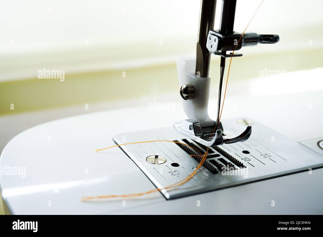 Sewing machine needle bobbin and stitch settings details close up view ...