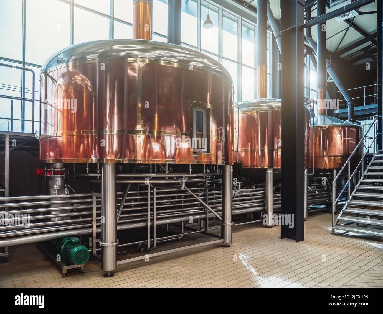 Beer tanks with many steel pipes in craft brewery Stock Photo - Alamy