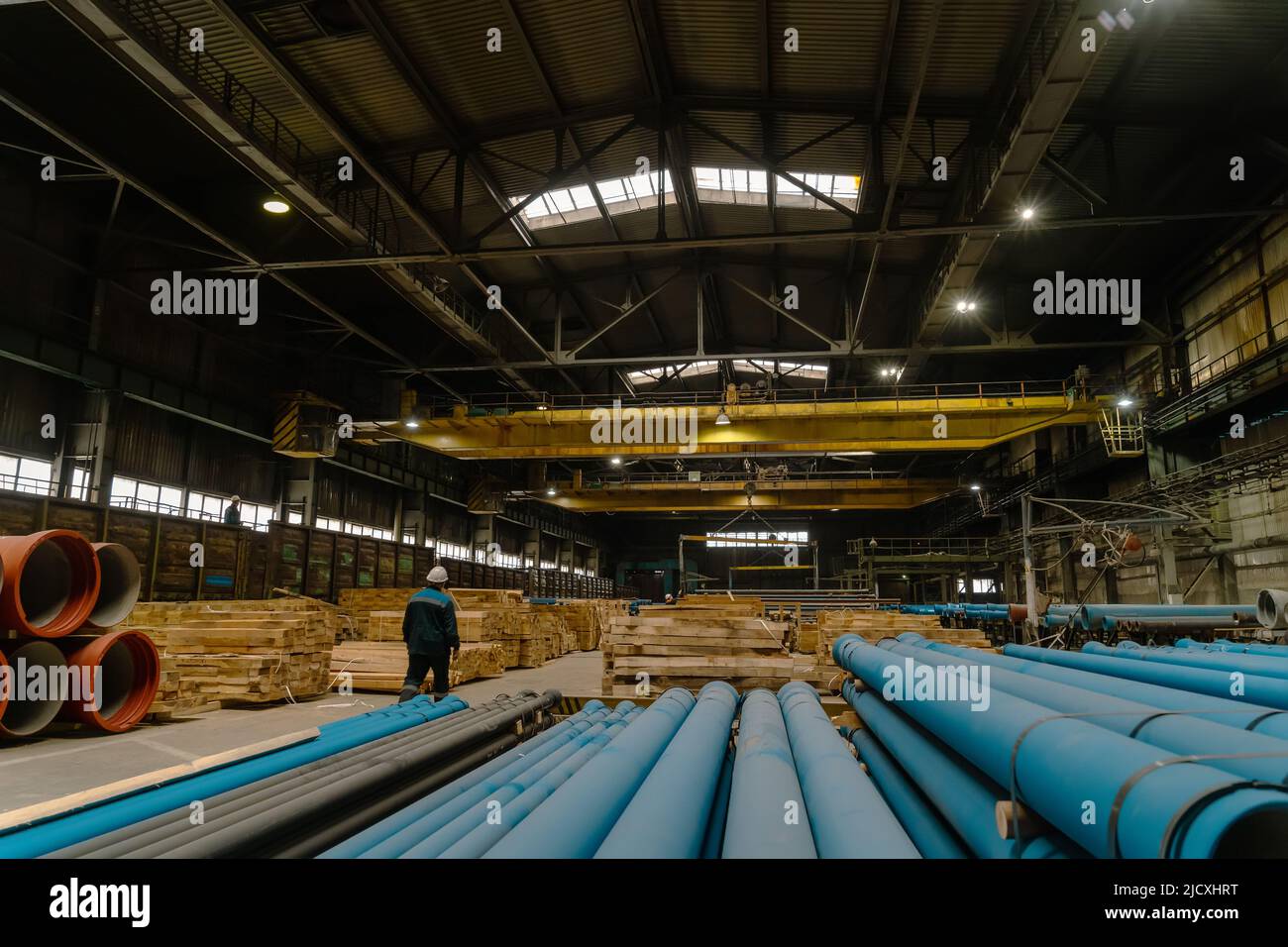 Group of blue metal pipes for water in metallurgical factory warehouse ...