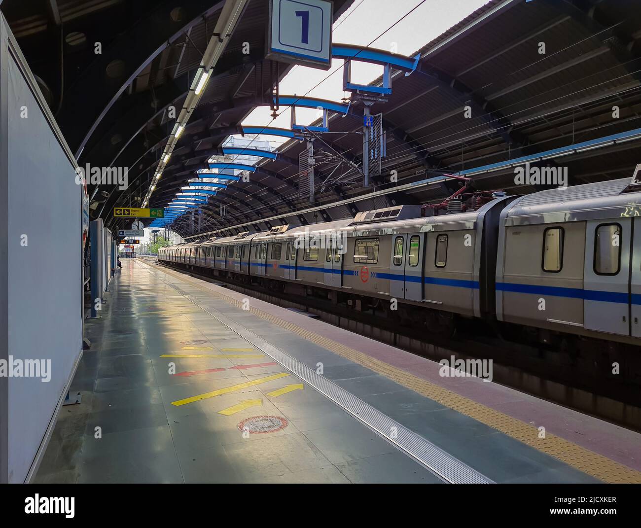 isolated train standing at vacant metro station at day from flat angle ...