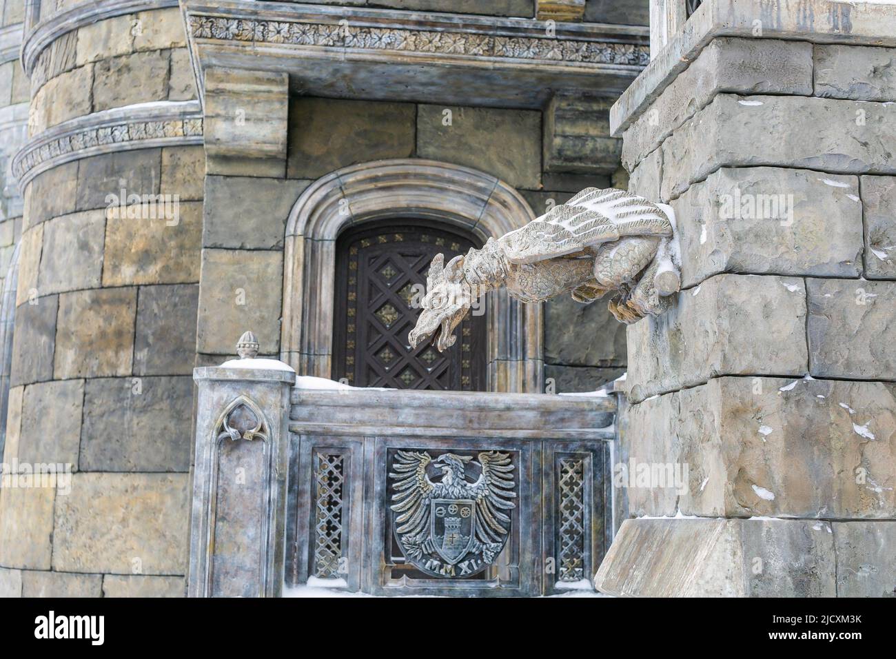 Gargoyle statue attached to the wall of the castle Stock Photo - Alamy