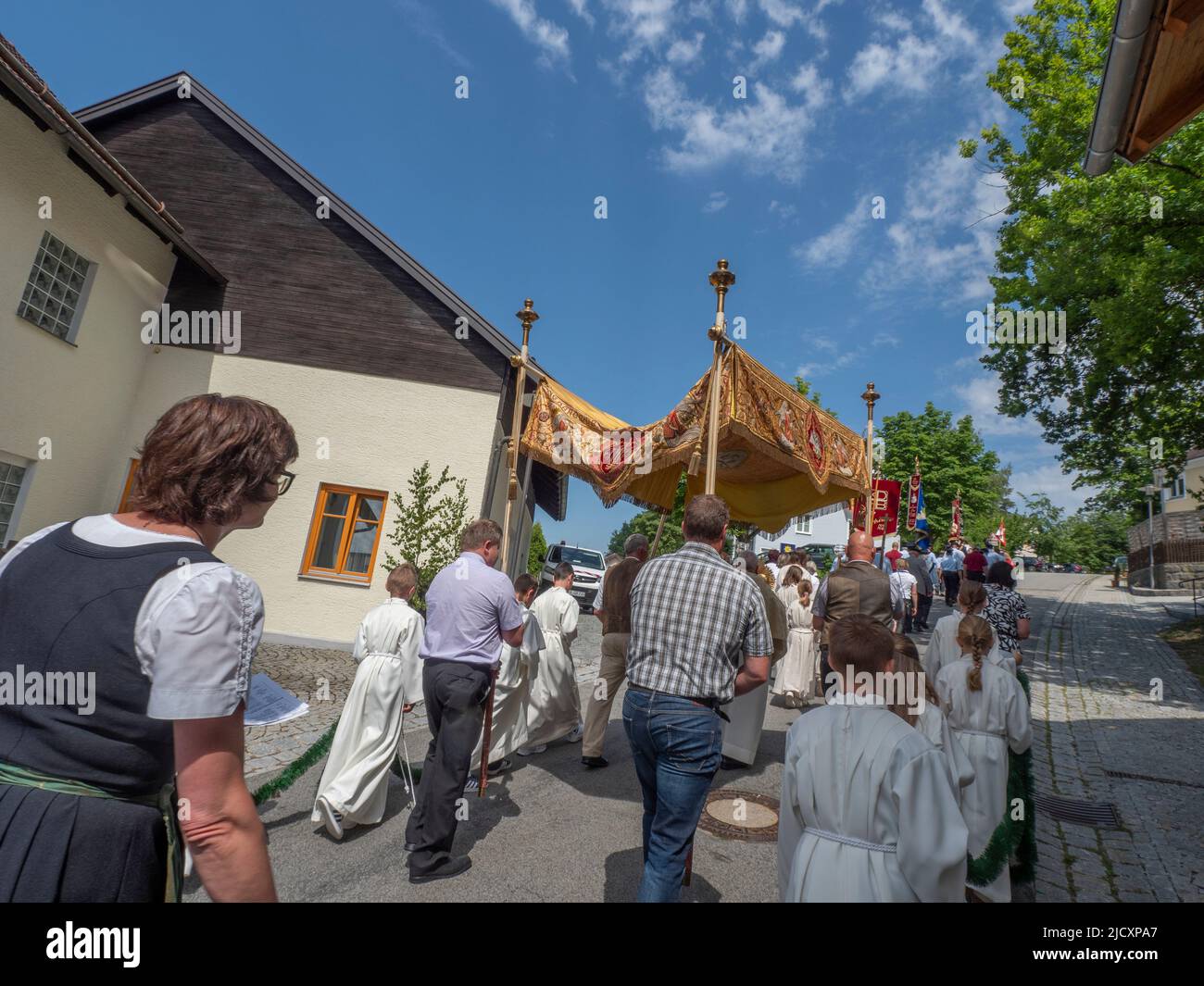 Peoples goes to chirch trougth the street. Catholics of the village of ...
