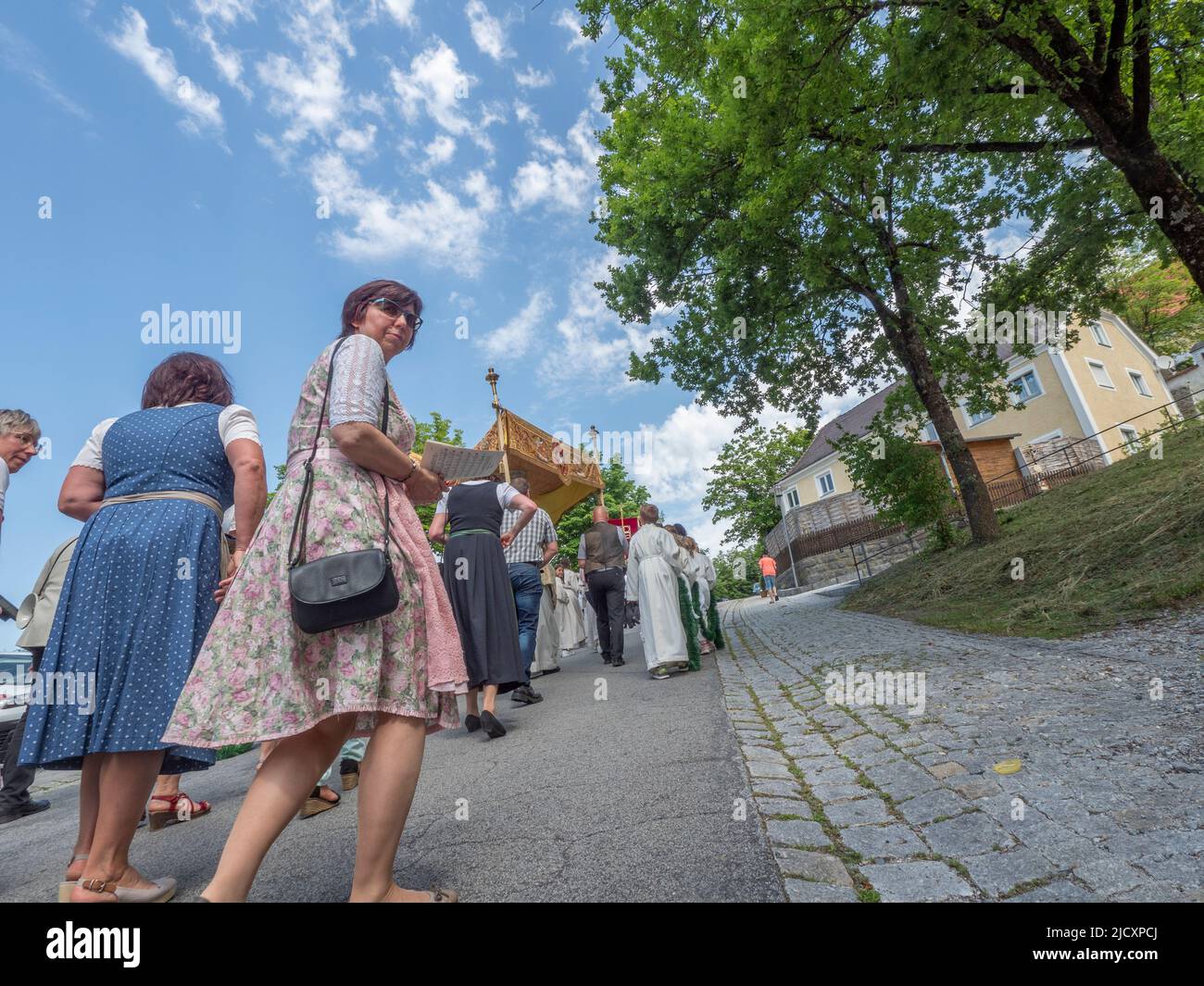 Peoples goes to chirch trougth the street. Catholics of the village of ...