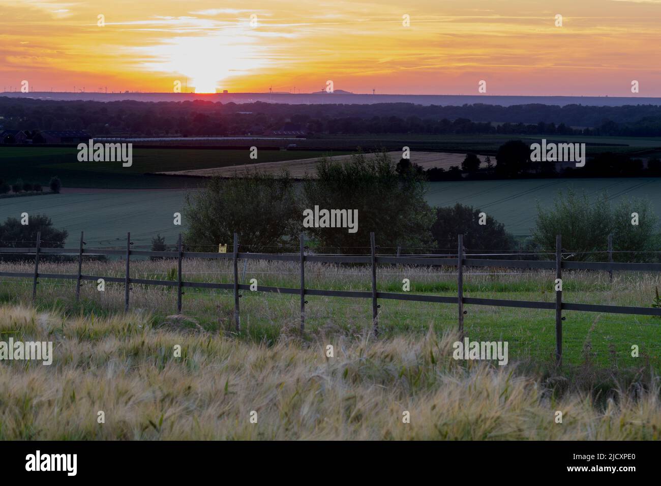 A golden sunset over the rolling hills in Banholt, south Limburg in the ...