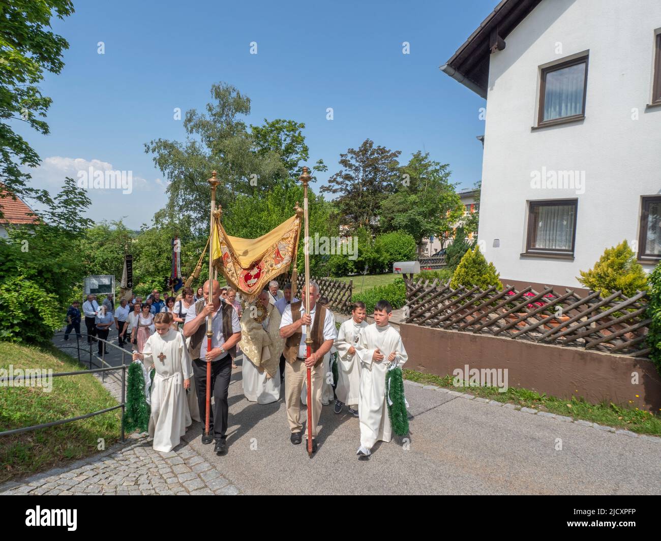Participants of the procession carry a canopy over the priest ...