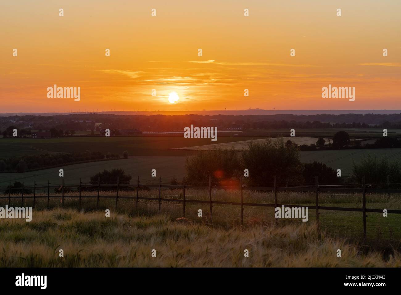A golden sunset over the rolling hills in Banholt, south Limburg in the ...