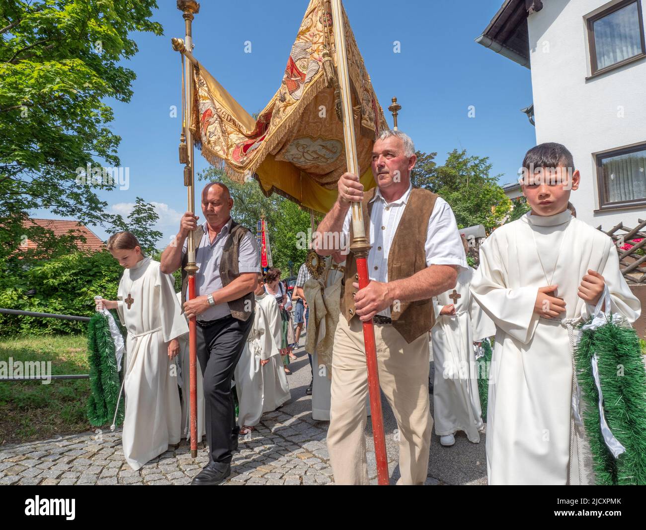 Participants of the procession carry a canopy over the priest ...