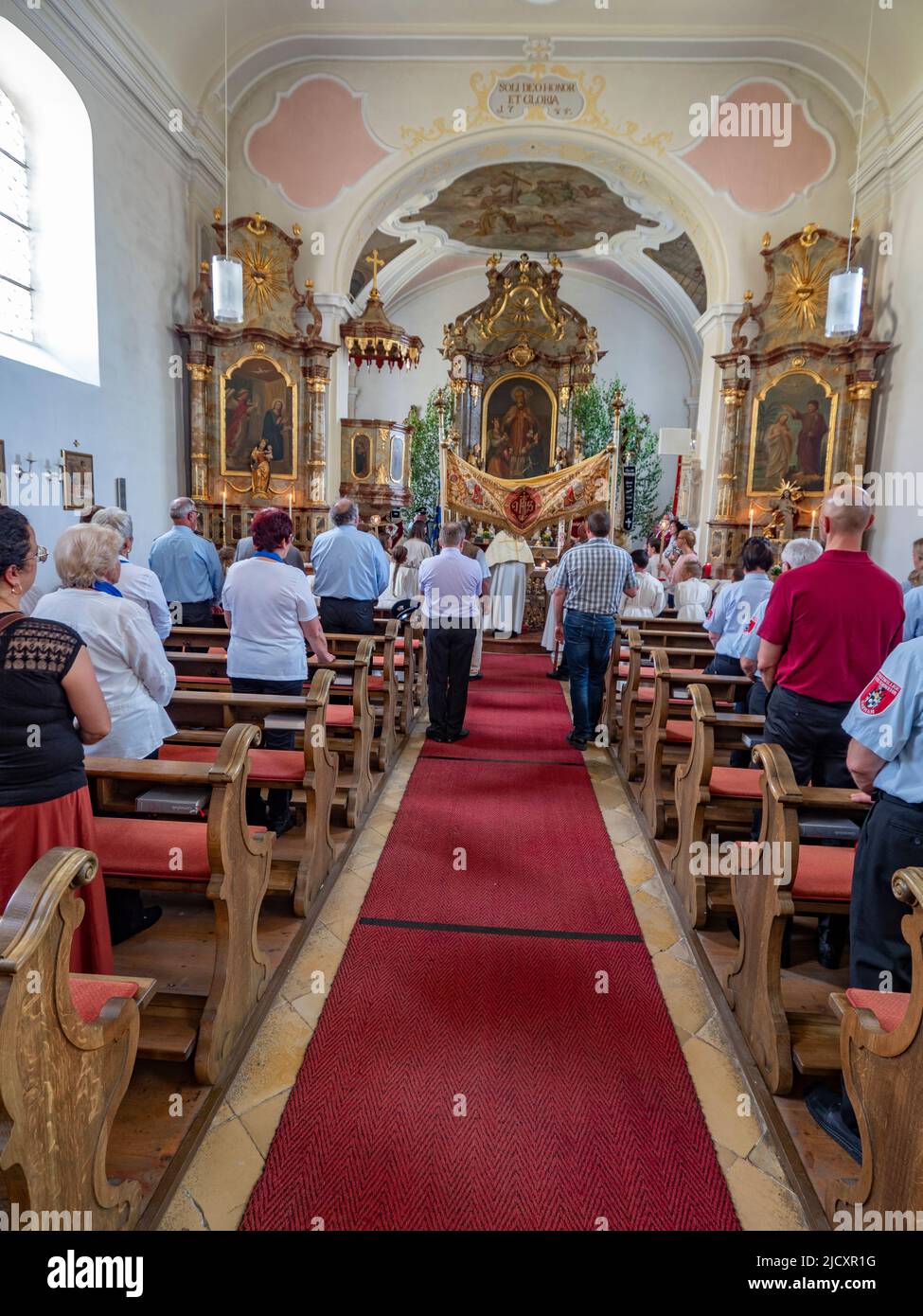 The priest reads a sermon in front of the parishioners. Catholics of ...