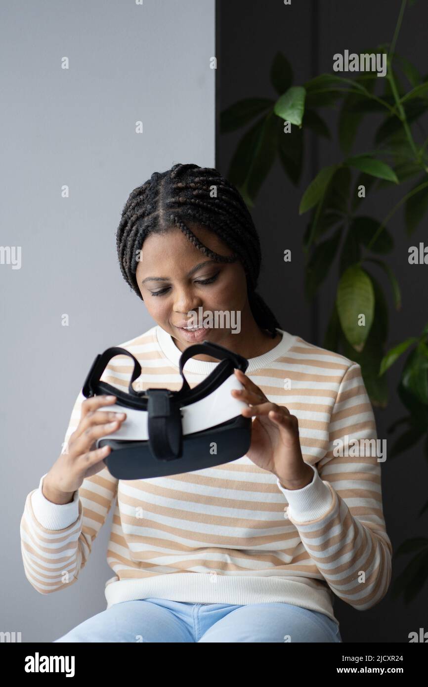 Vr goggles for gaming, shopping or work. Young african woman hold ...