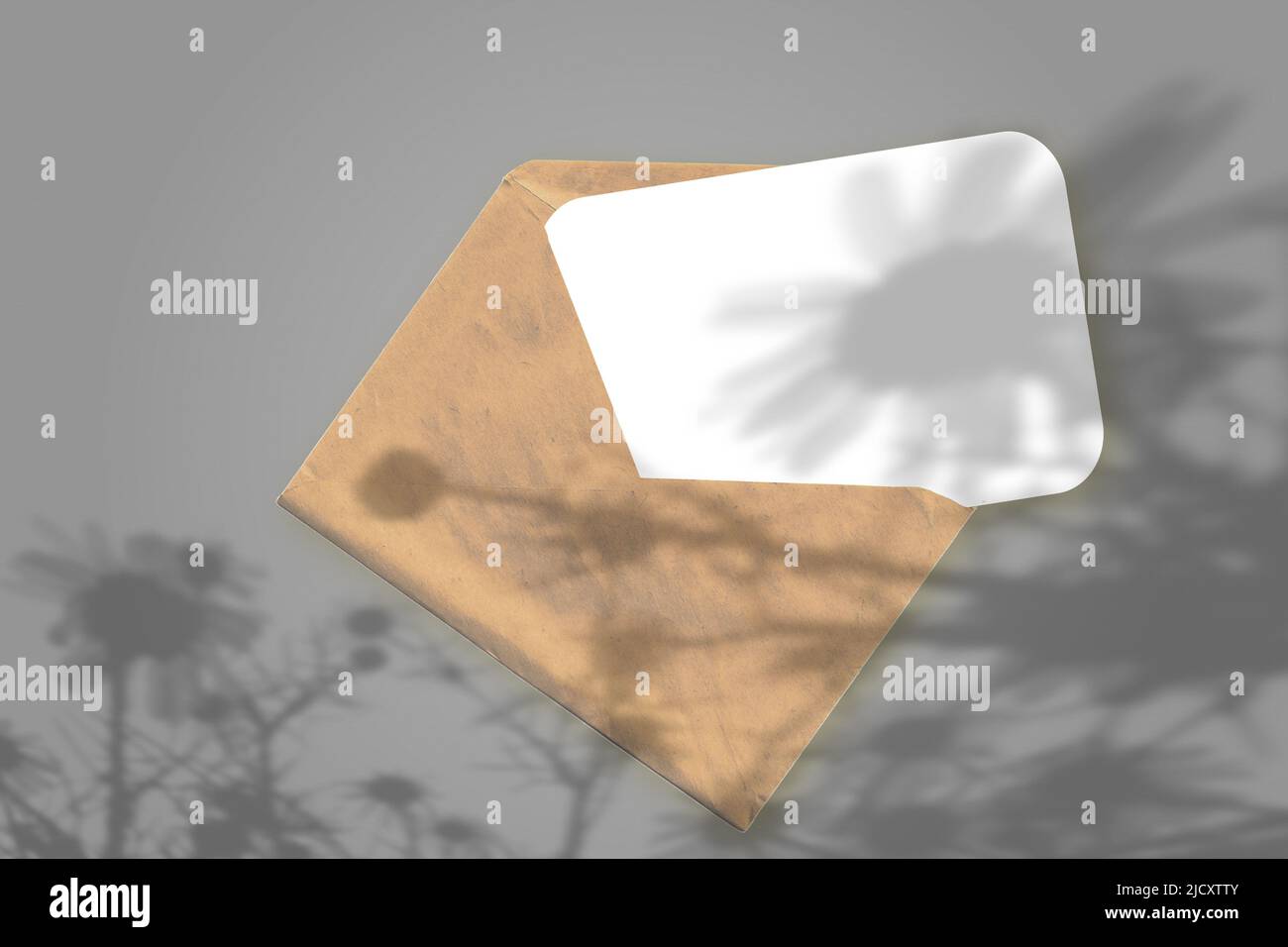 An envelope with sheet of textured white paper on violet background ...