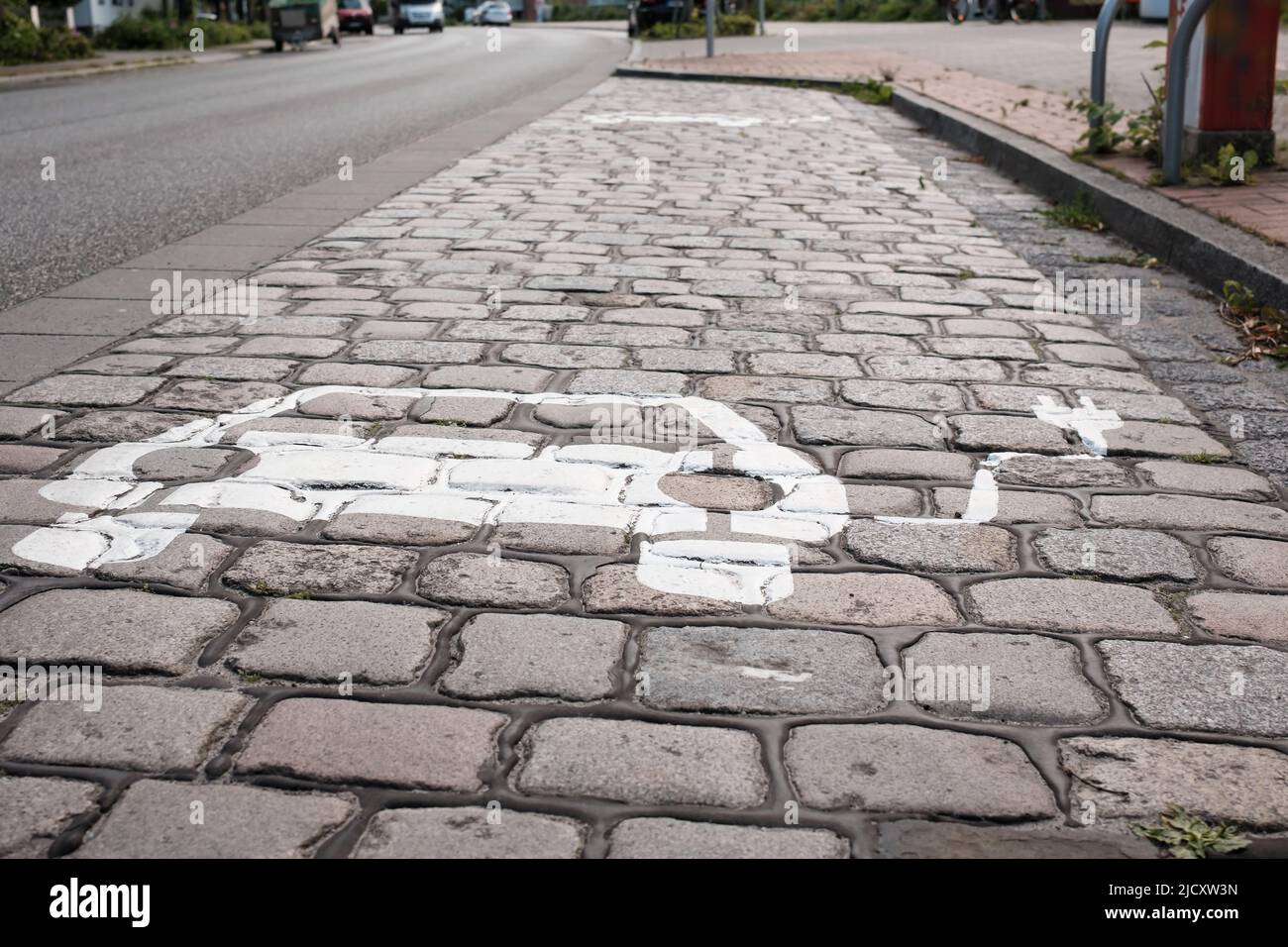 Electric car charging sign drawn in a parking lot, on a city street ...