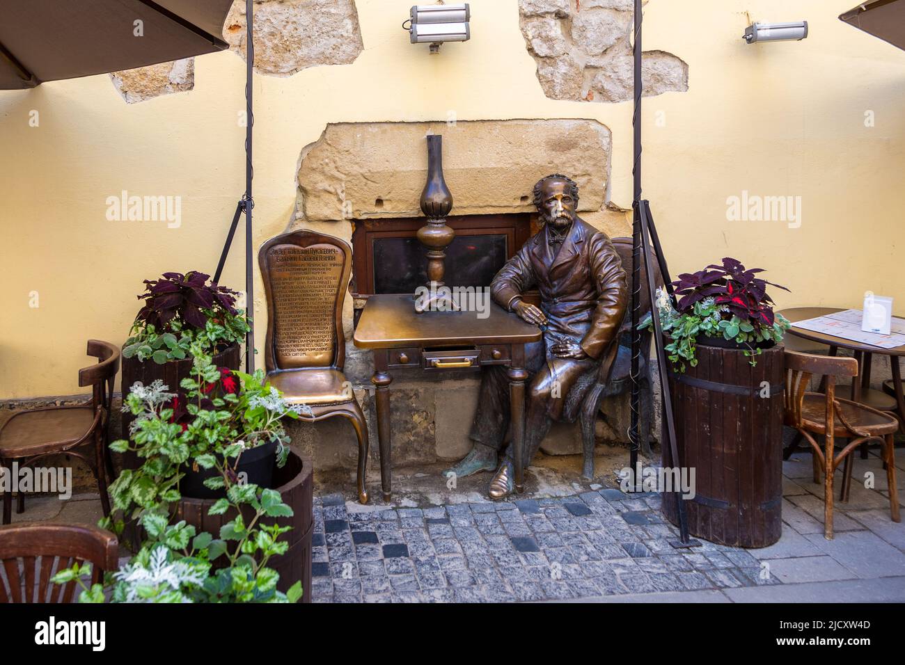Lviv, Ukraine - 09 June 2018: Statue of a man sitting at a table ...