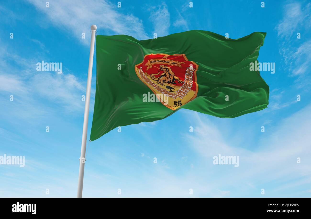 official flag of East Nusa Tenggara Indonesia at cloudy sky background ...