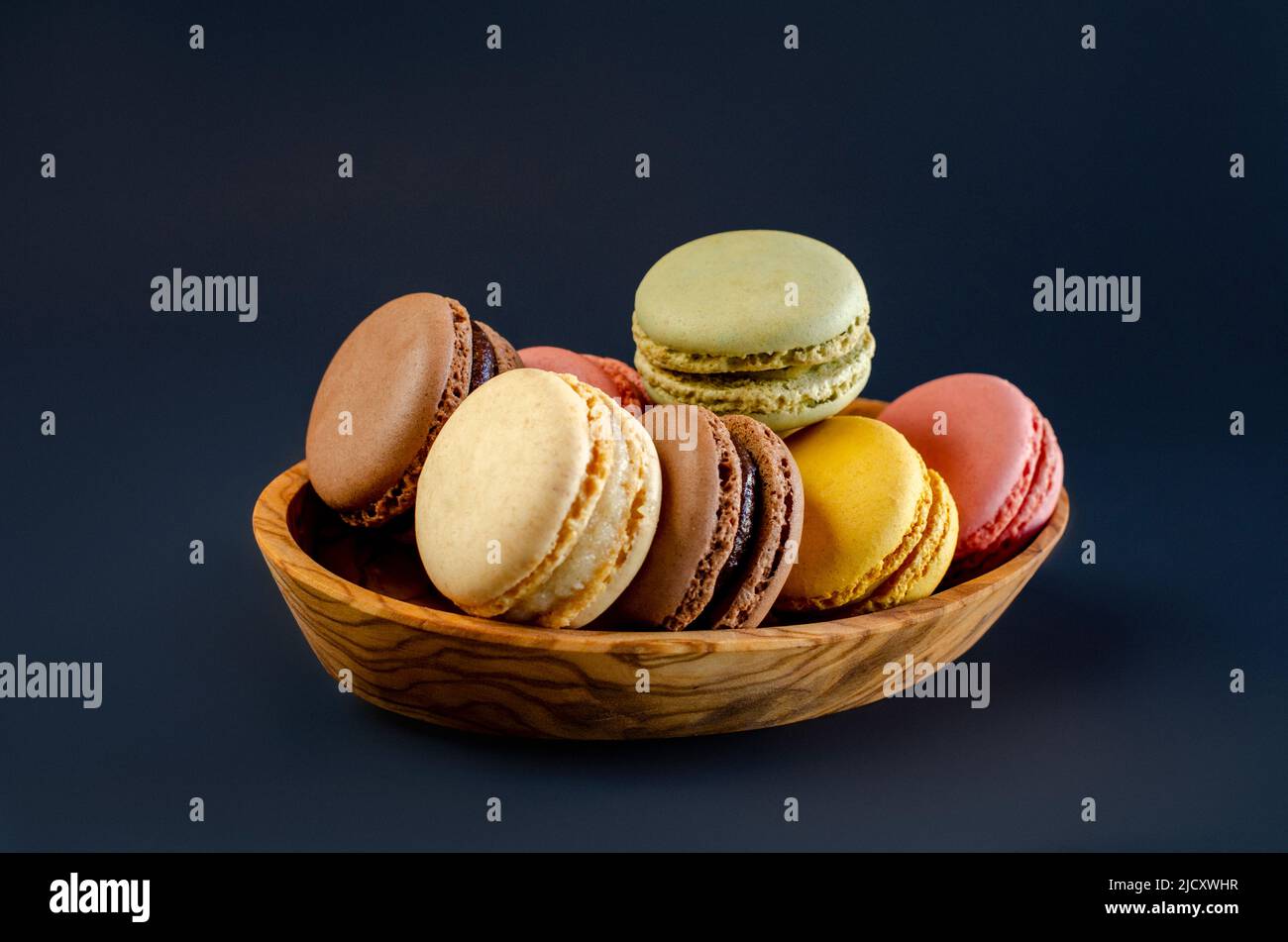Row of delicious colorful French macaroons of different flavors on ...
