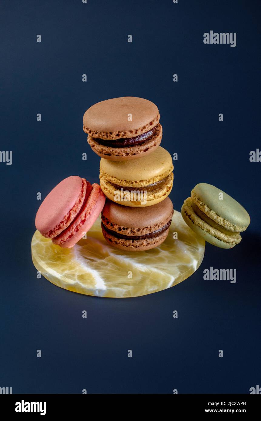 Row of delicious colorful French macaroons of different flavors on ...