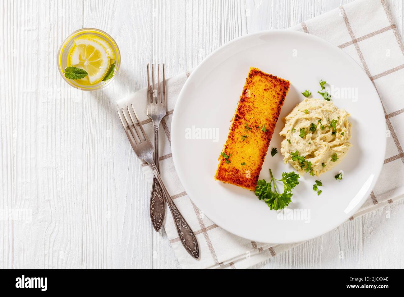 Baccala mantecato, creamed salt cod with toasted polenta on white plate ...