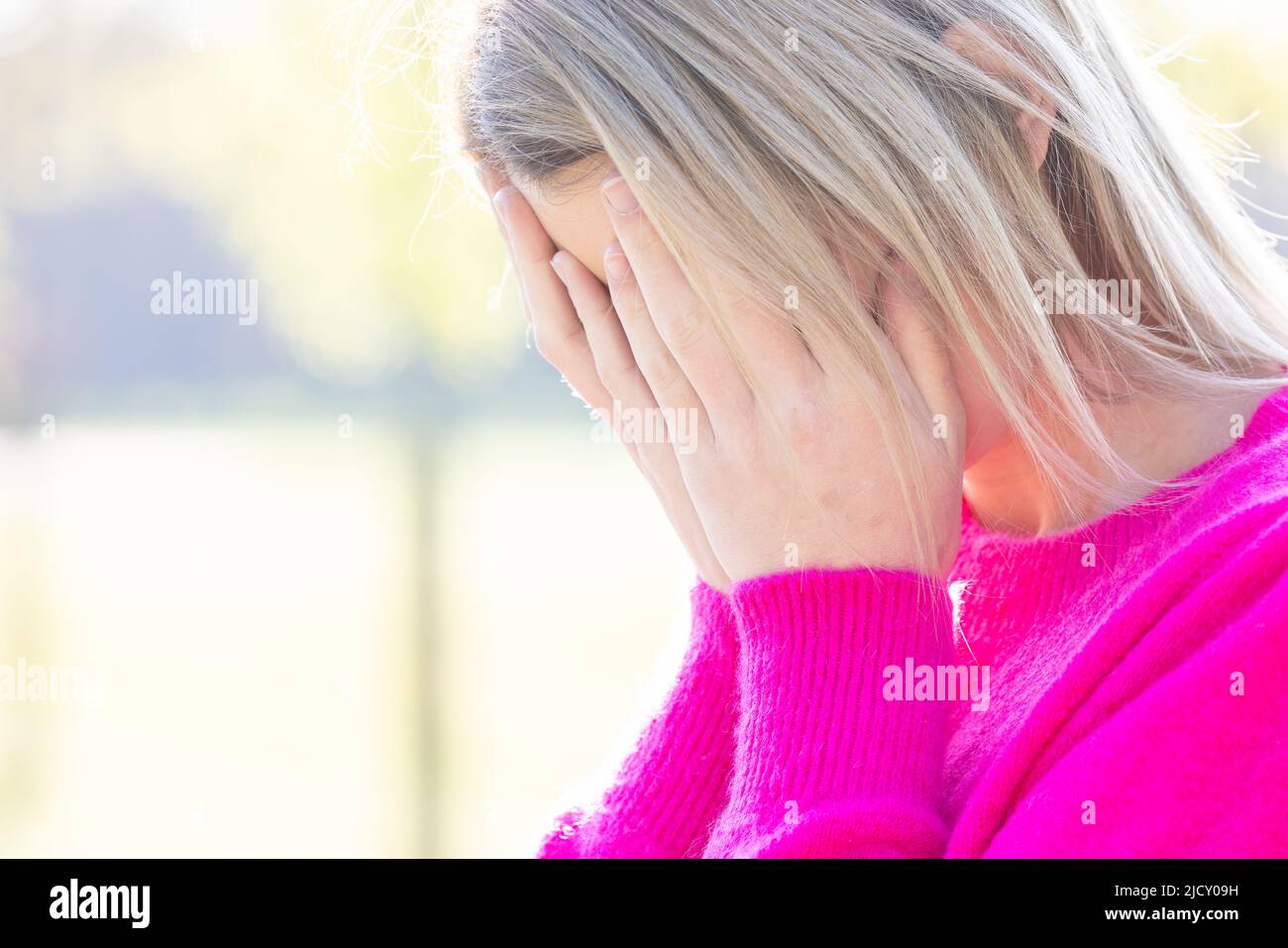 Sad tired young woman touching forehead having headache migraine or ...