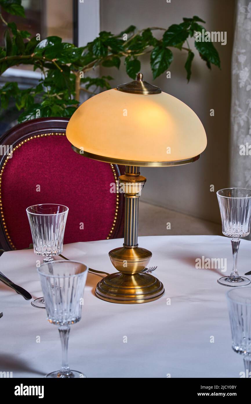 An old lamp stands on a table in a restaurant Stock Photo - Alamy