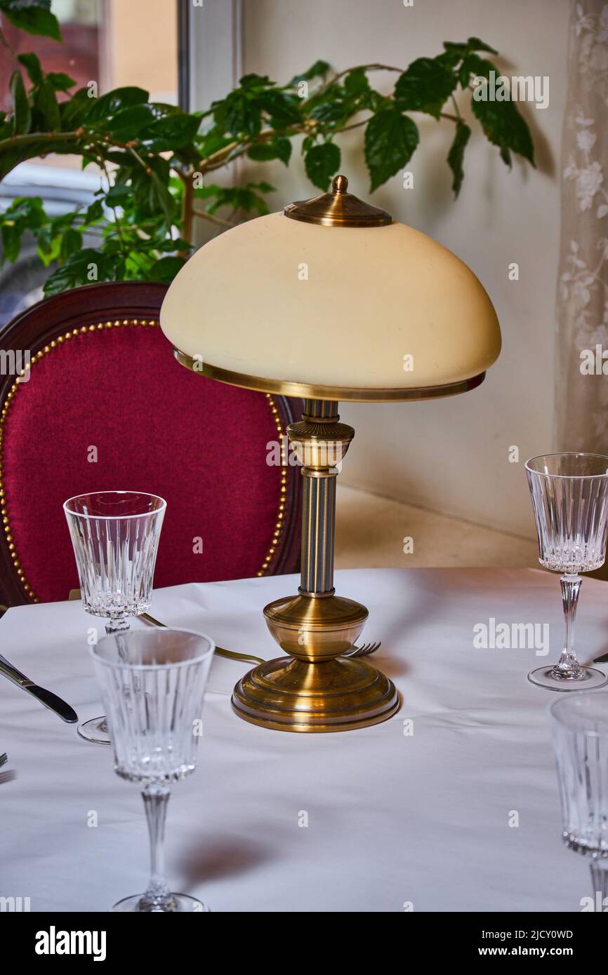 An old lamp stands on a table in a restaurant Stock Photo - Alamy