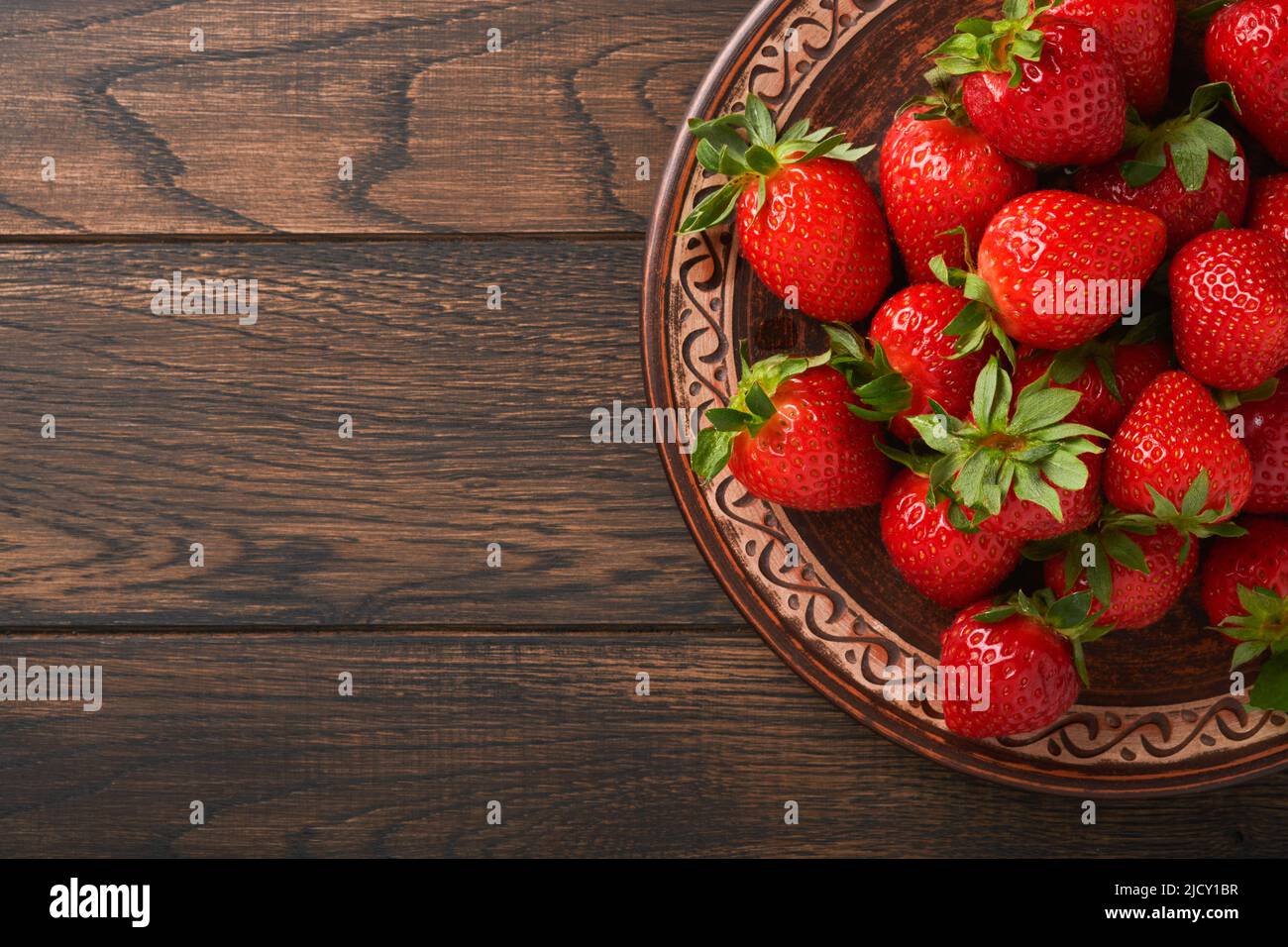 Strawberry berry. Fresh red strawberry in ceramic rustic plate in ...