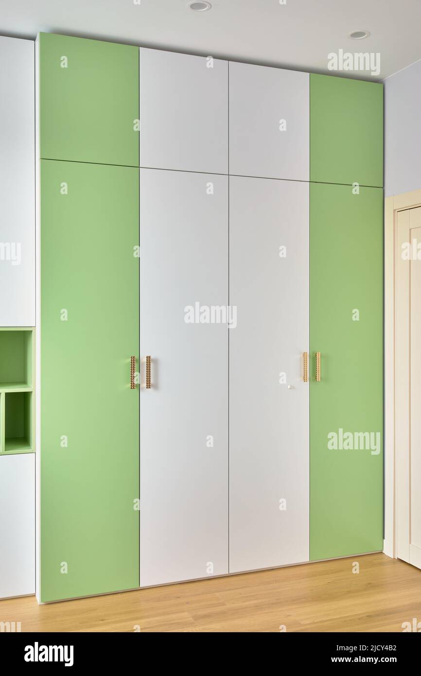Beautiful wardrobe in green and white colors Stock Photo - Alamy