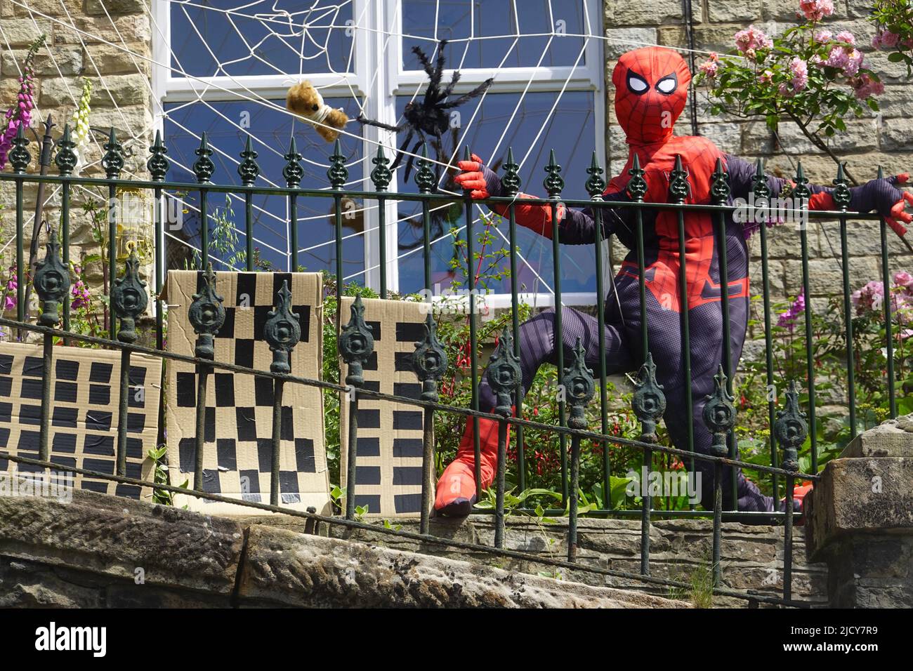 Spiderman at the front of a house with a web in the window Stock Photo ...