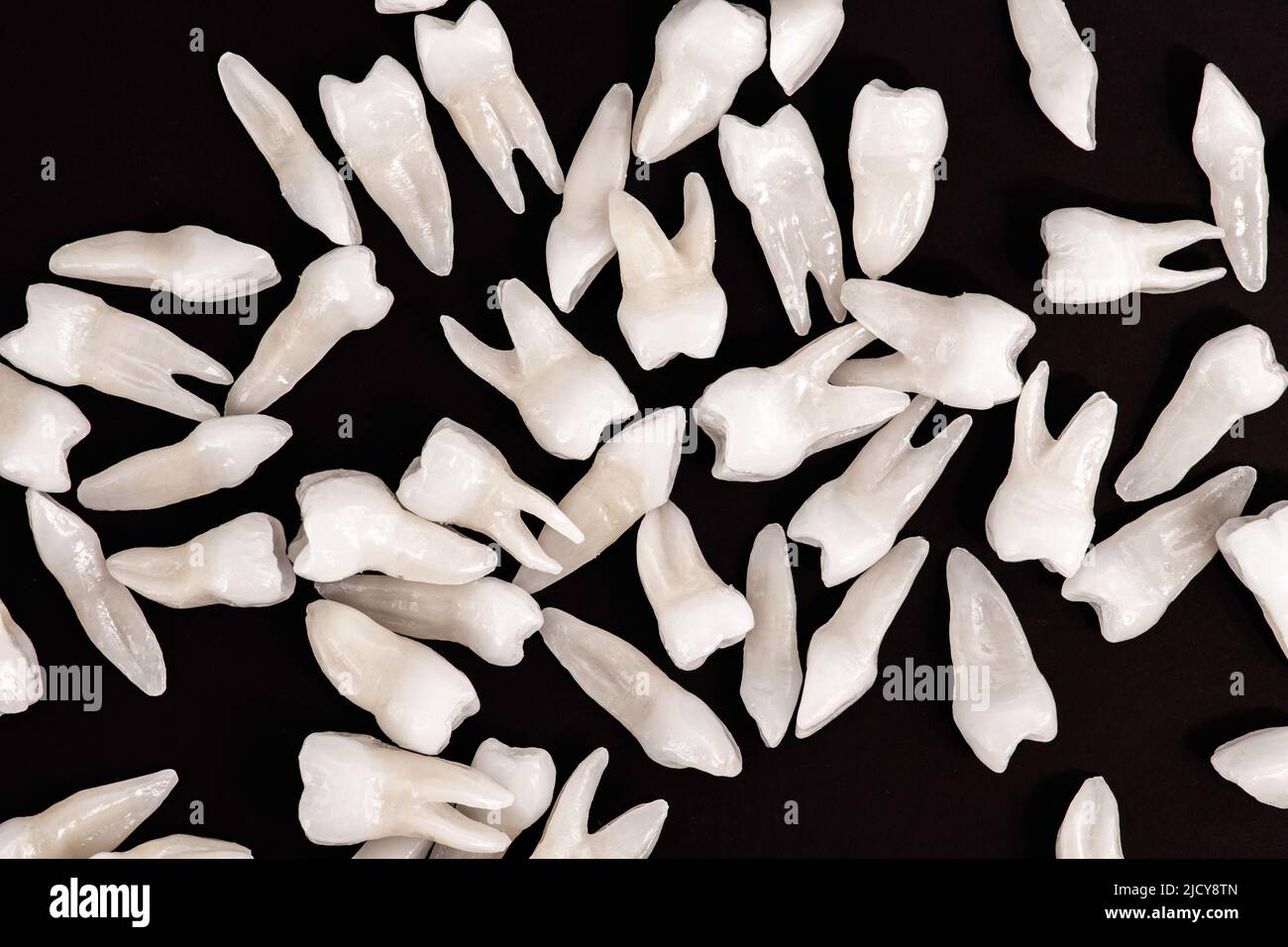 Teeth implant and crown installation process parts isolated on a blue ...