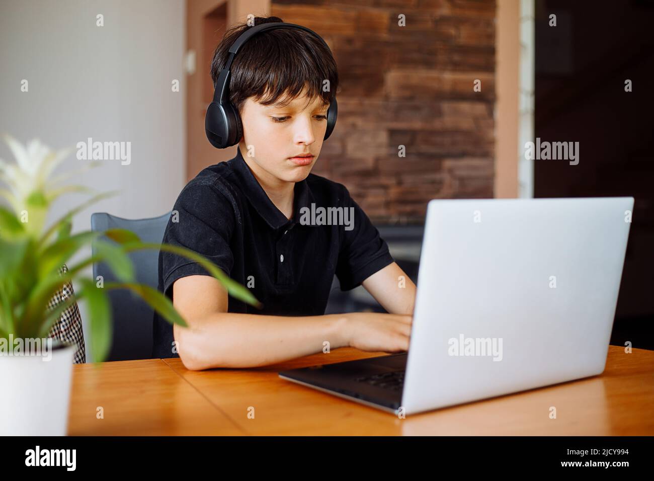 Boy sitting at computer typing hi-res stock photography and images - Alamy