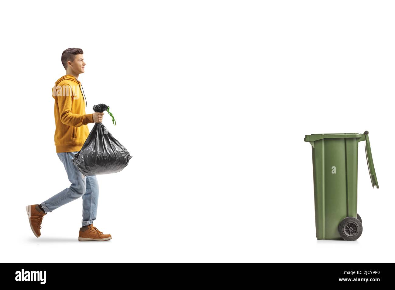 Full length profile shot of a guy carrying a plastic waste bag and ...