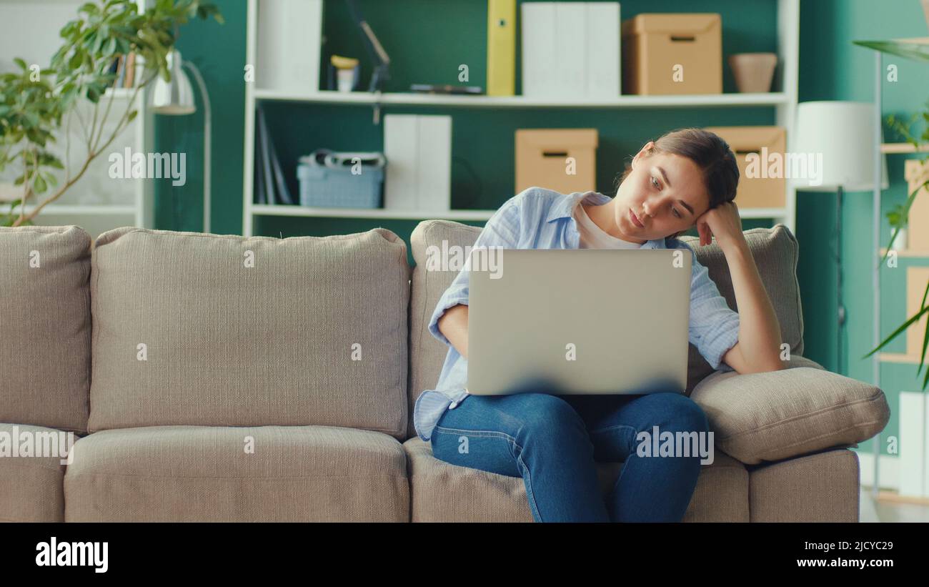 Freelancer Sitting on the Sofa Working Remotely From Home Feeling ...