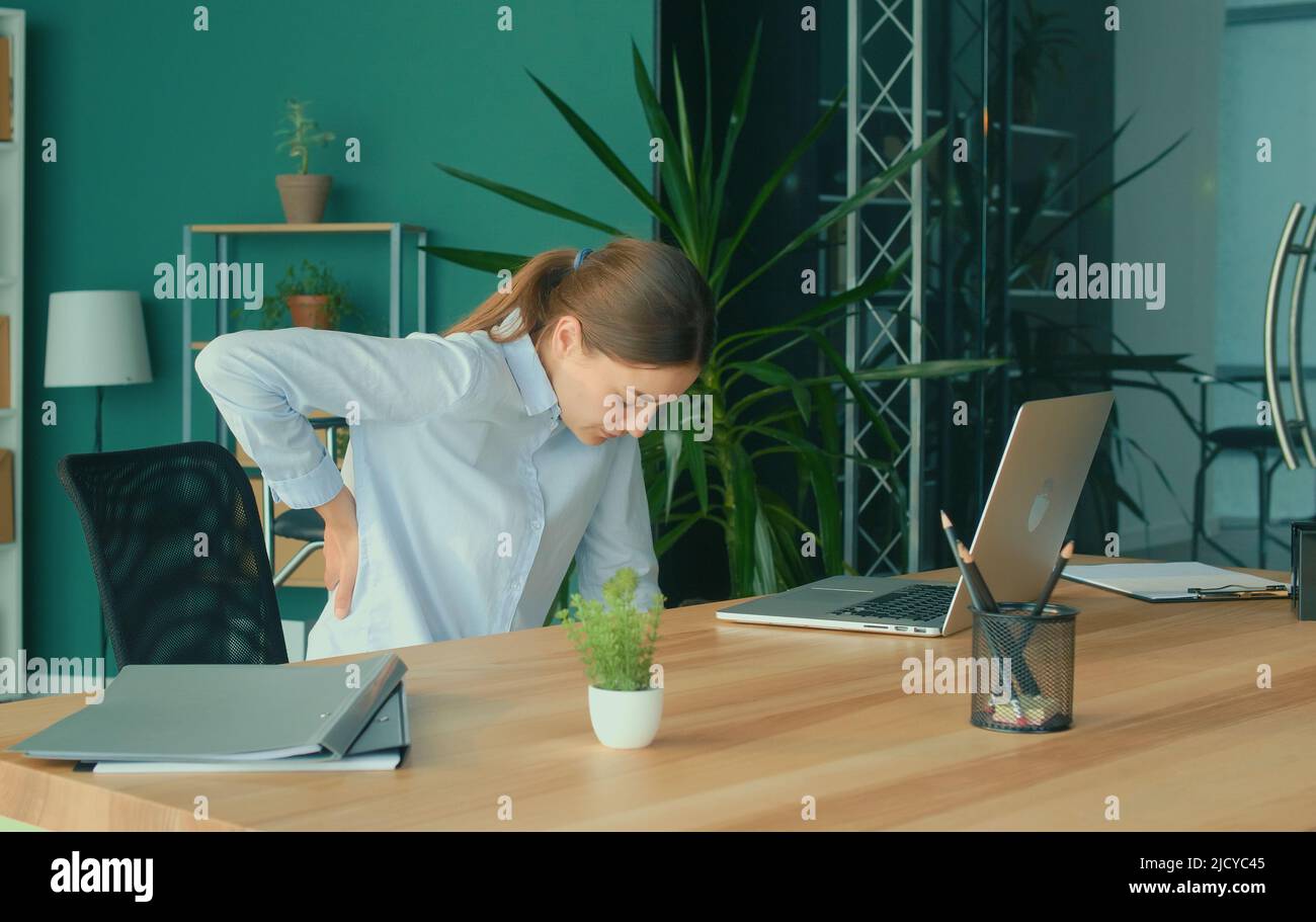 Office Syndrome.Woman Trying to Get Up From the Table Suddenly Feeling ...