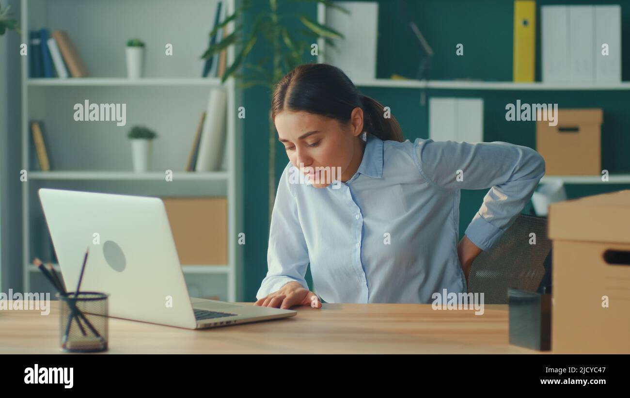 Office Syndrome.Woman Trying to Get Up From the Table Suddenly Feeling ...