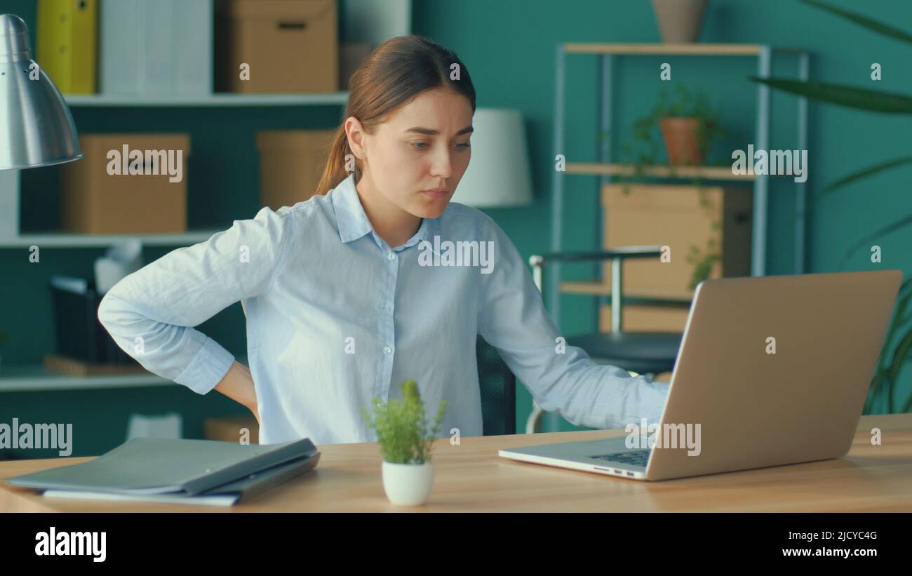 Office Syndrome.Woman Trying to Get Up From the Table Suddenly Feeling ...