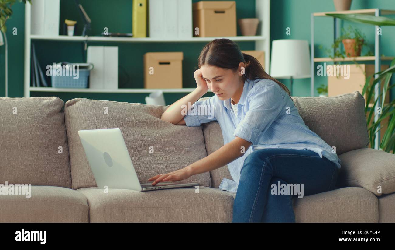 Freelancer Sitting on the Sofa Working Remotely From Home Feeling ...