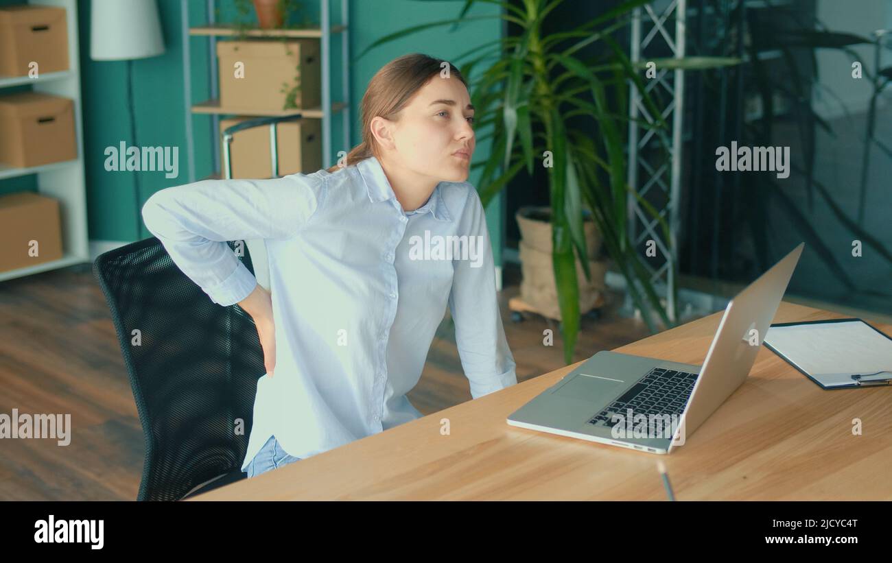 Office Syndrome.Woman Trying to Get Up From the Table Suddenly Feeling ...