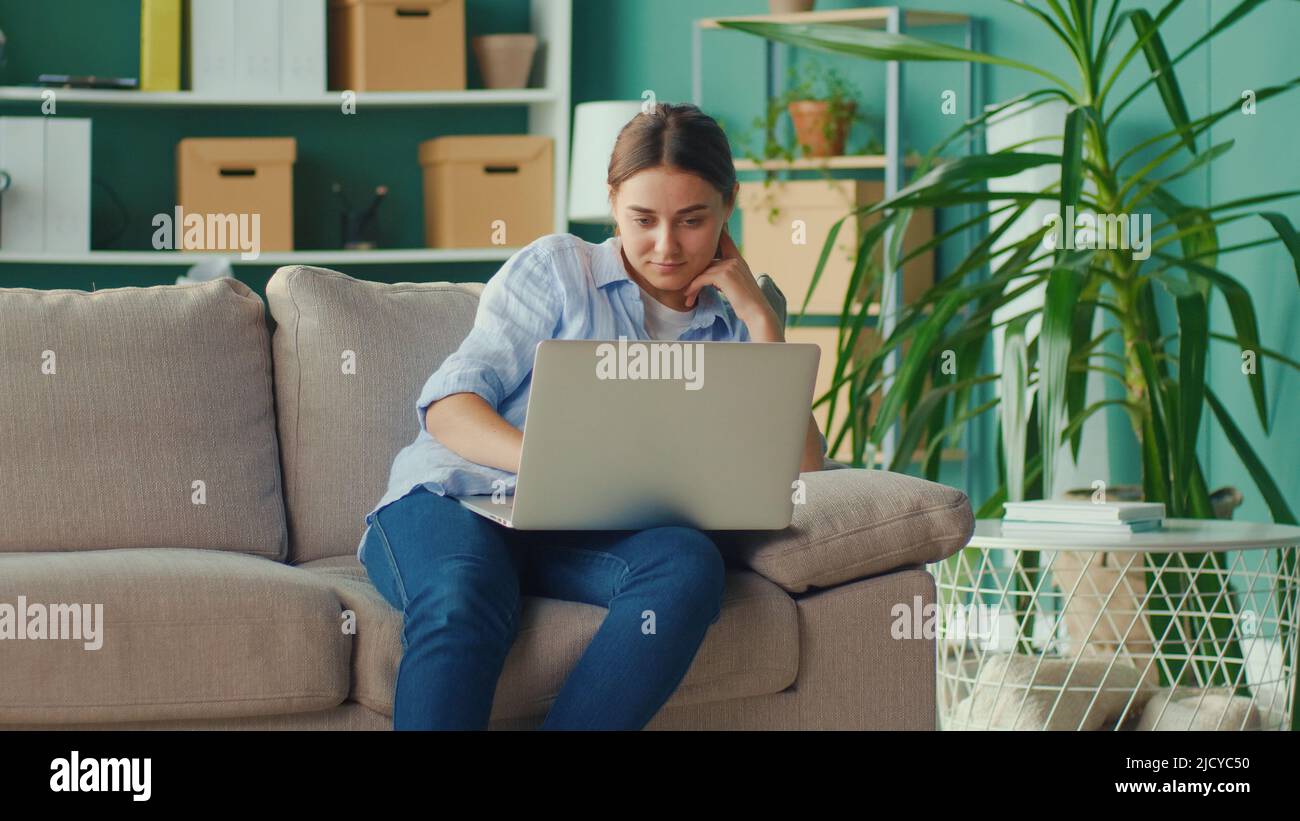 Freelancer Sitting on the Sofa Working Remotely From Home Feeling ...