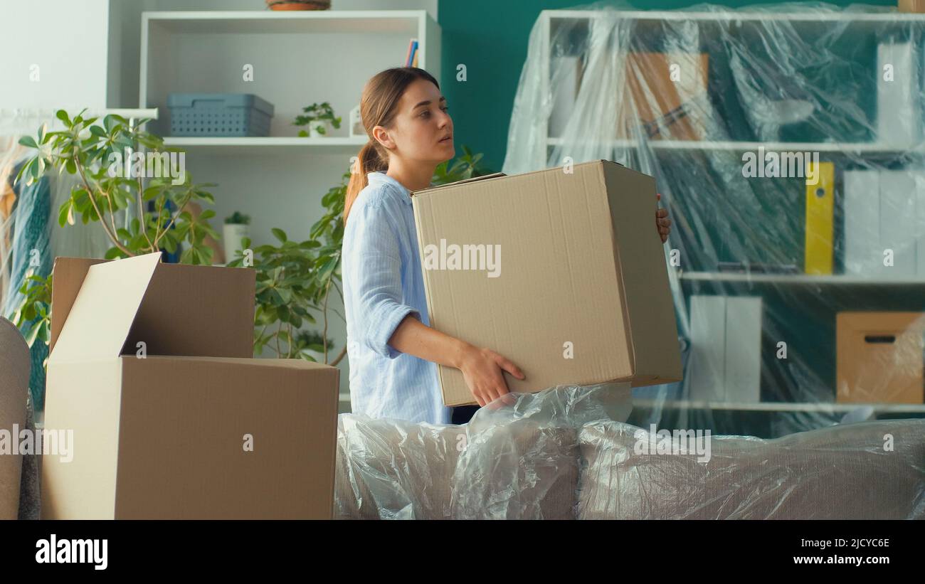 Woman Feels Sudden Back Pain When Trying to Lift a Carton Box. Woman ...