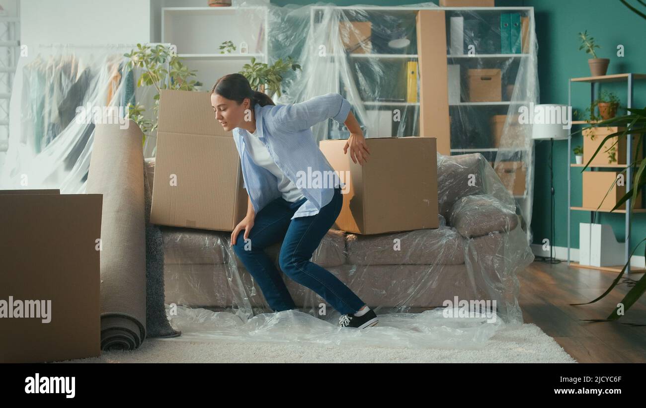 Woman Feels Sudden Back Pain When Trying to Lift a Carton Box. Woman ...