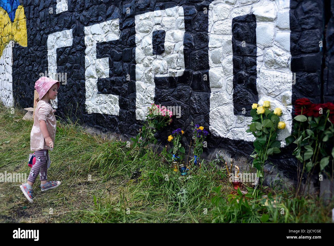 KYIV, UKRAINE - JUNE 16, 2022 - A little girl stands before the ...
