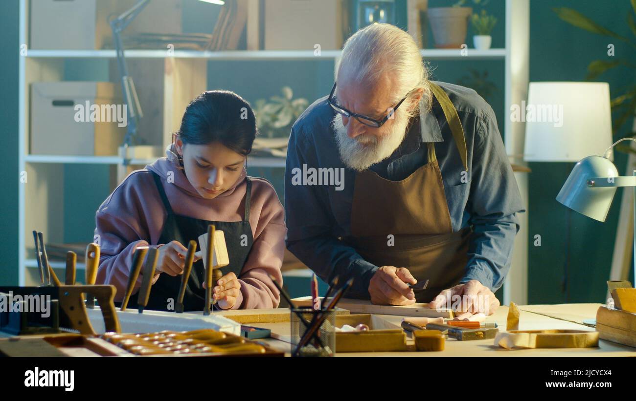 Grandfather Carpenter with Granddaughter Work with Wood to Create Items ...
