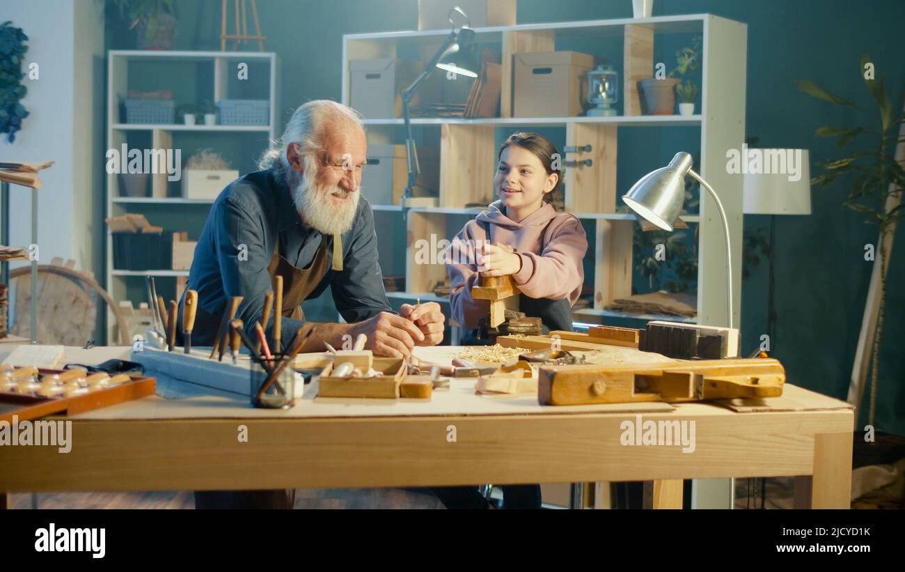 Grandfather Carpenter with Granddaughter Work with Wood to Create Items ...