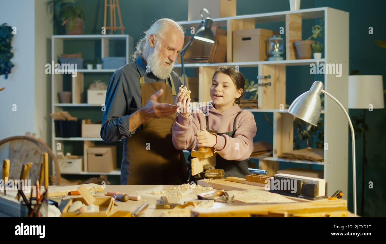Grandfather Carpenter with Granddaughter Work with Wood to Create Items ...