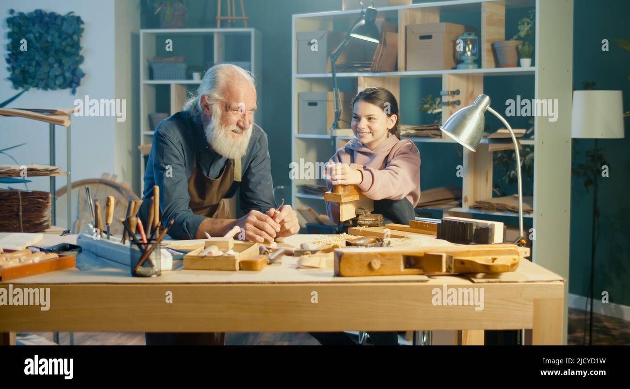 Grandfather Carpenter with Granddaughter Work with Wood to Create Items ...