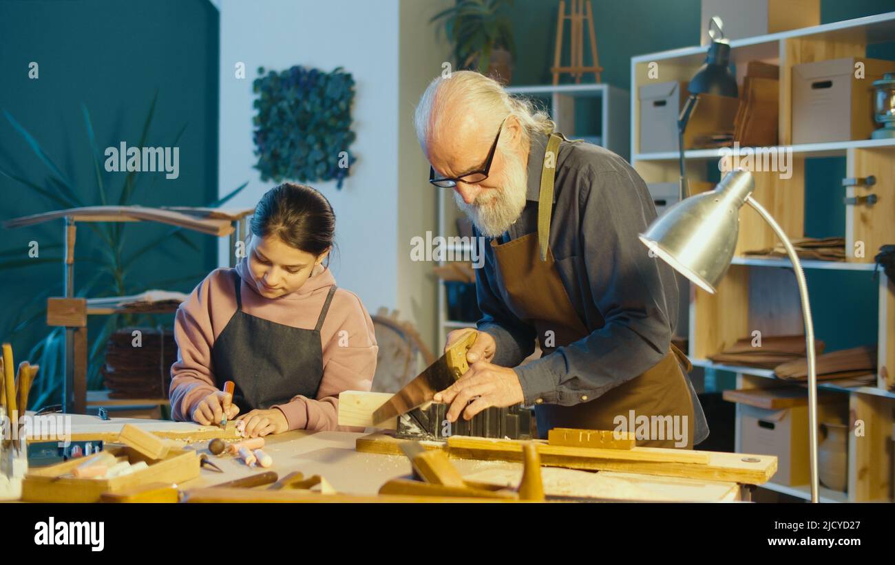 Grandfather Carpenter with Granddaughter Work with Wood to Create Items ...