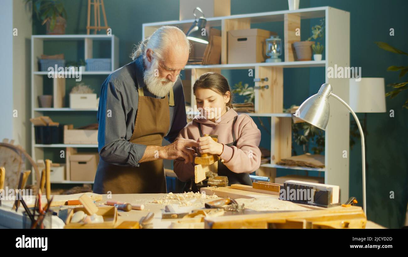 Grandfather Carpenter with Granddaughter Work with Wood to Create Items ...