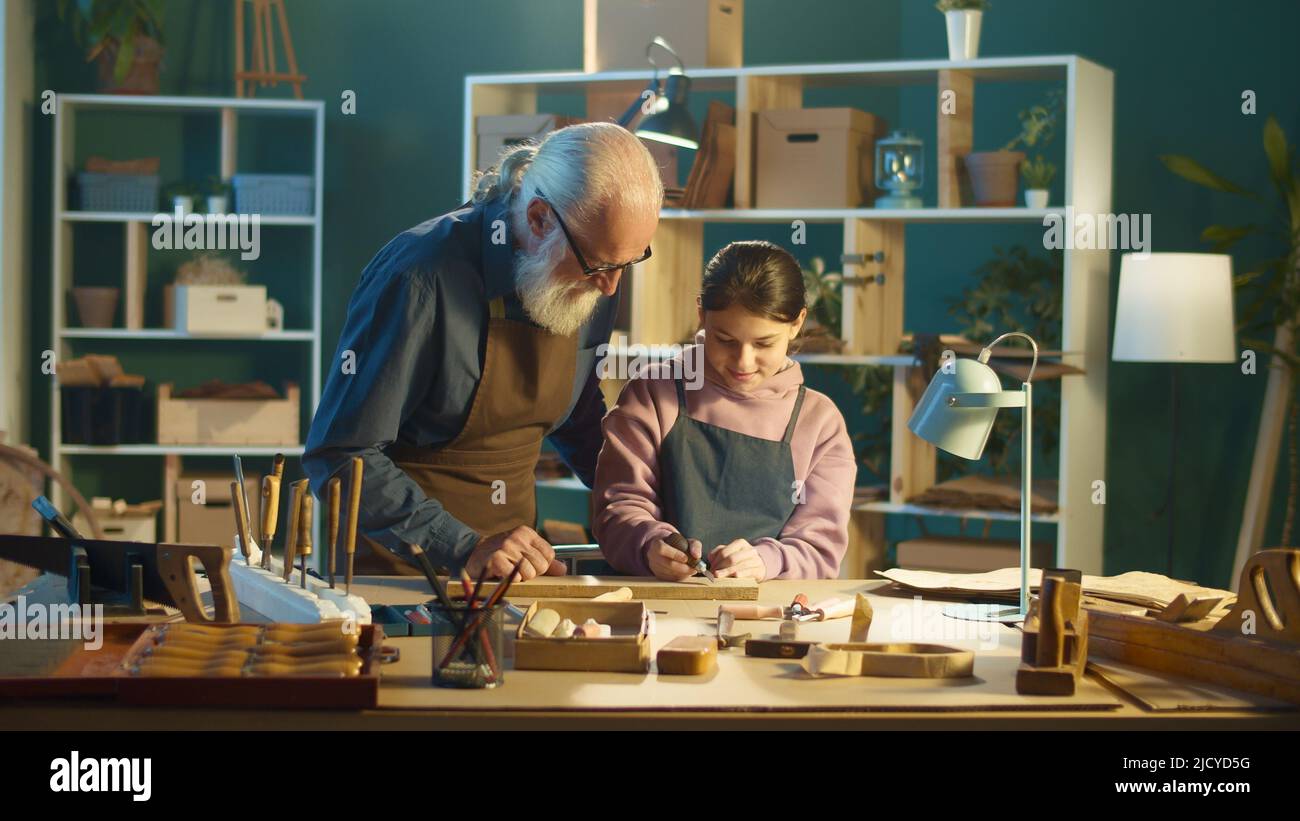 Grandfather Carpenter with his Teenage Granddaughter Works in the ...