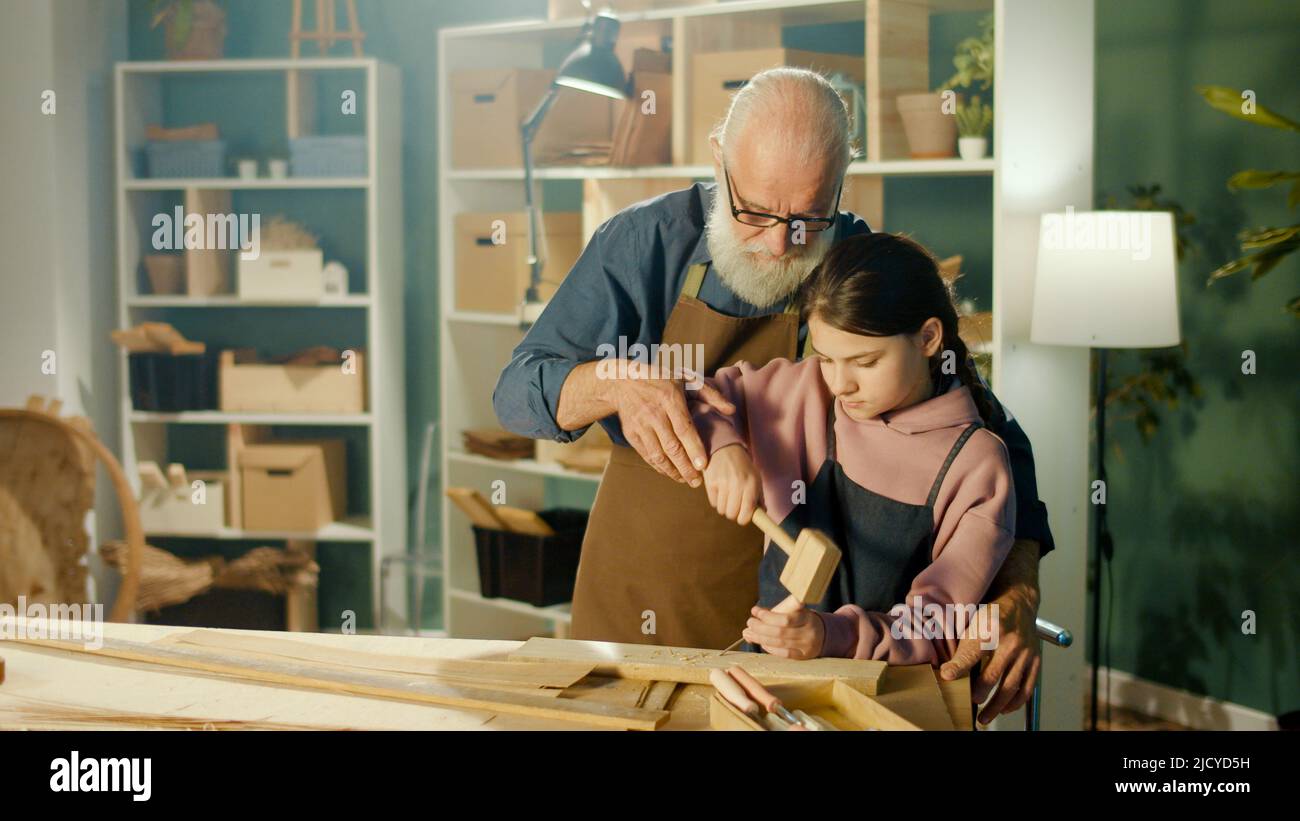 Grandfather Carpenter with his Teenage Granddaughter Works in the ...