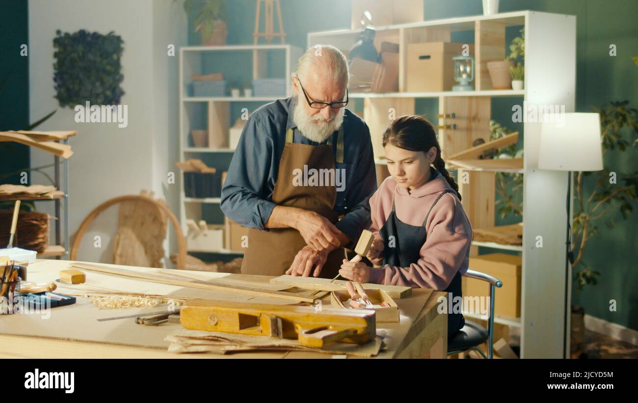 Grandfather Carpenter with his Teenage Granddaughter Works in the ...