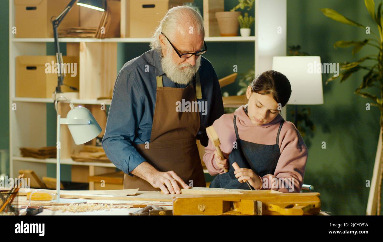 Grandfather Carpenter with his Teenage Granddaughter Works in the ...
